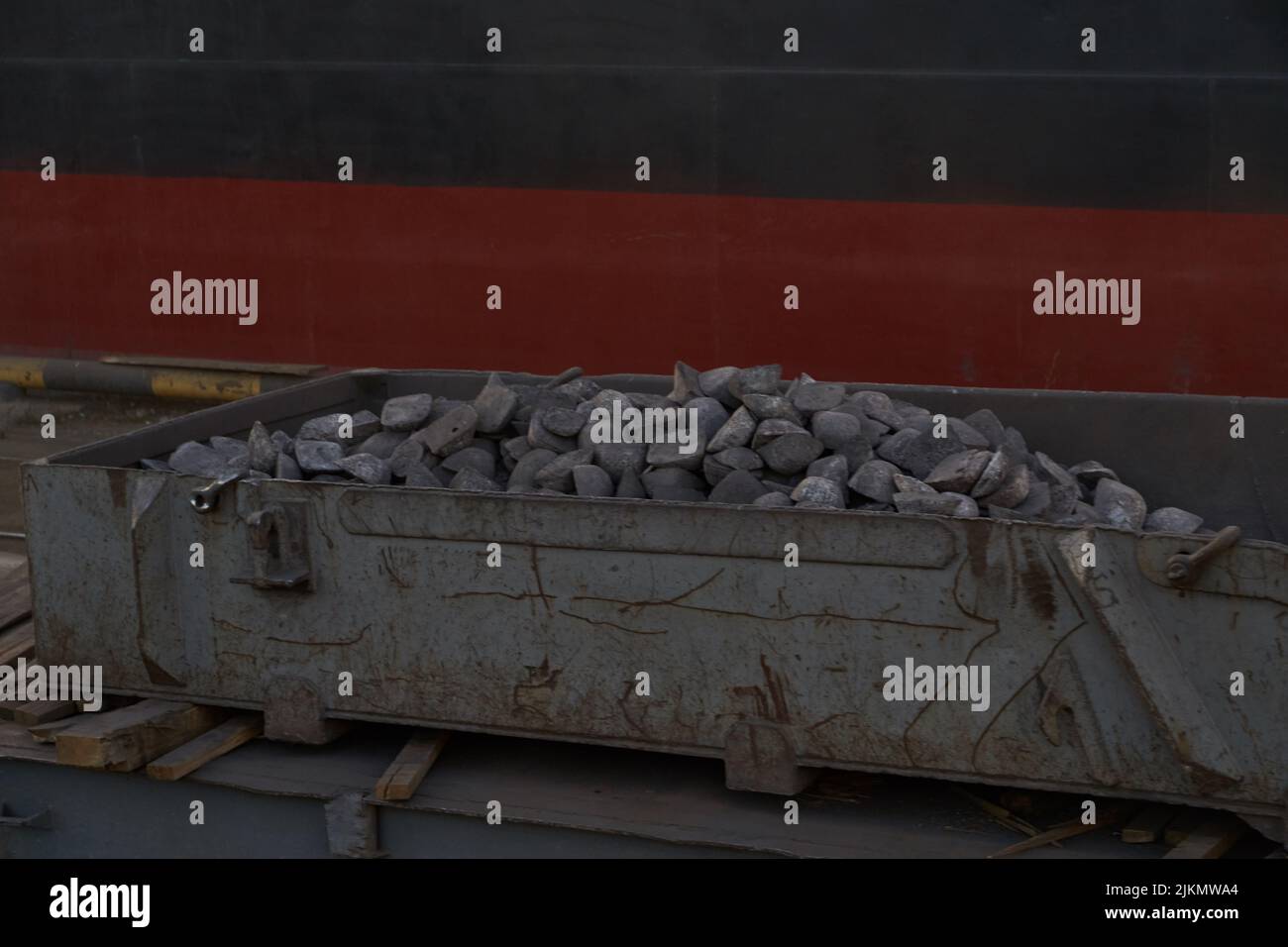 Loading cast iron ingots on ship bulk. Loading metal on ship ...
