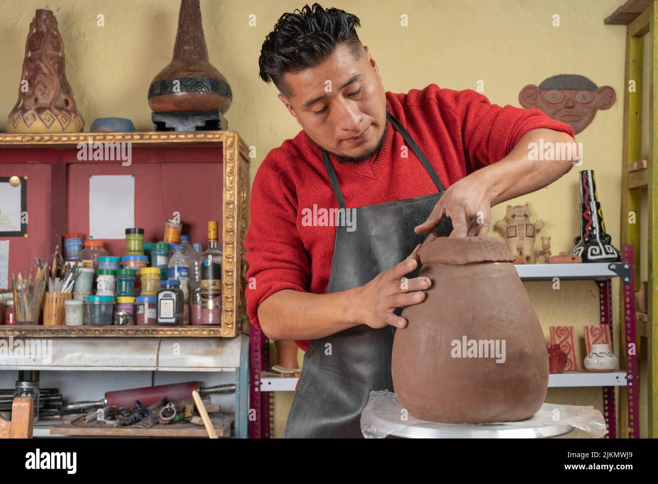 Potter standing making a ceramic vessel in his workshop Stock Photo - Alamy