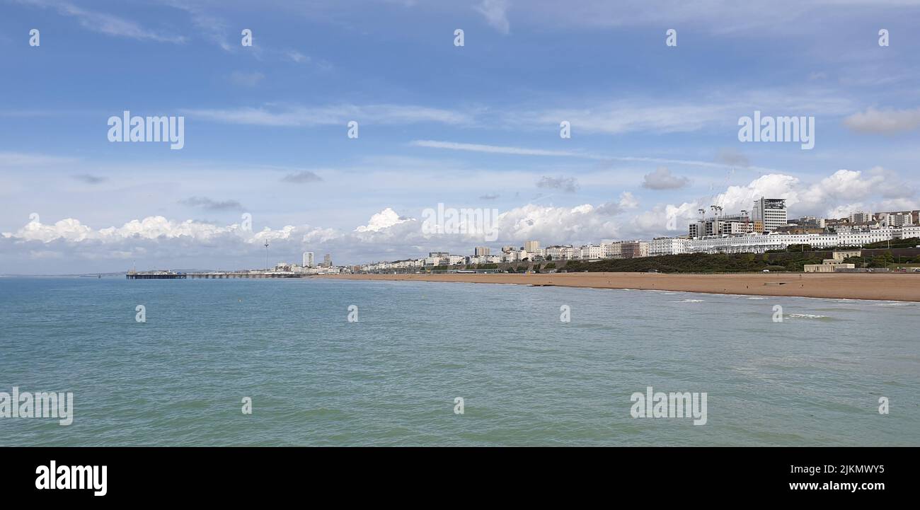 A panoramic scene of the Brighton beach in England with urban buildings ...