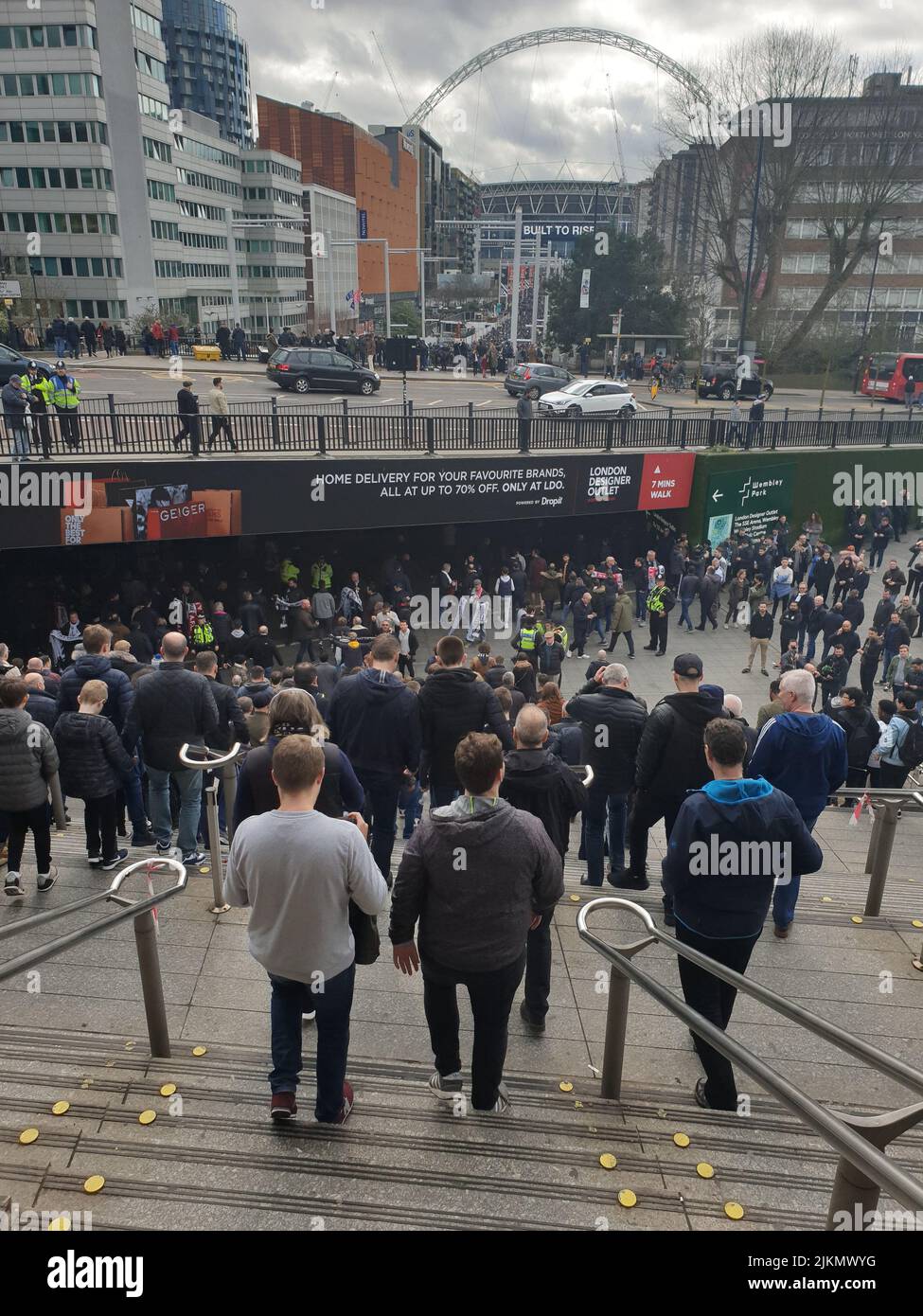 A back shot of people walking to Wembley stadium on football match day ...