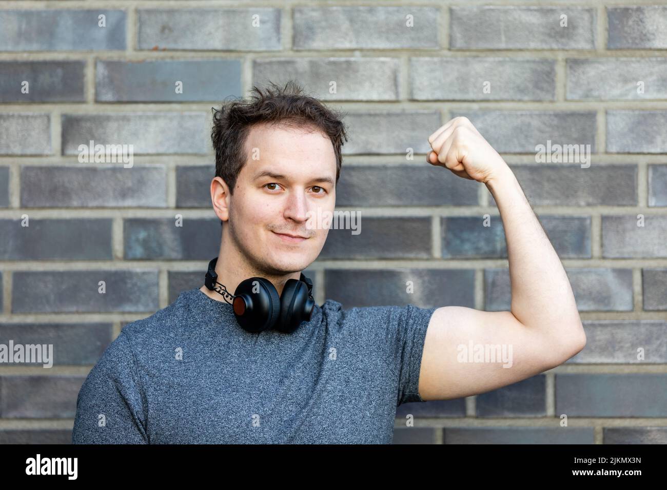 Young man shows his arm muscles during fitness workout Stock Photo - Alamy