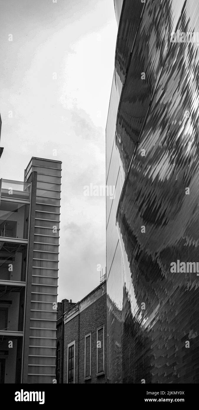 A vertical grayscale shot of a glazed building in London Stock Photo ...