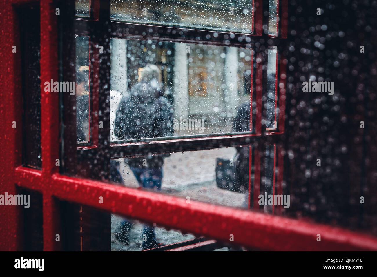 A beautiful shot of a walking person from the window of a London phone ...