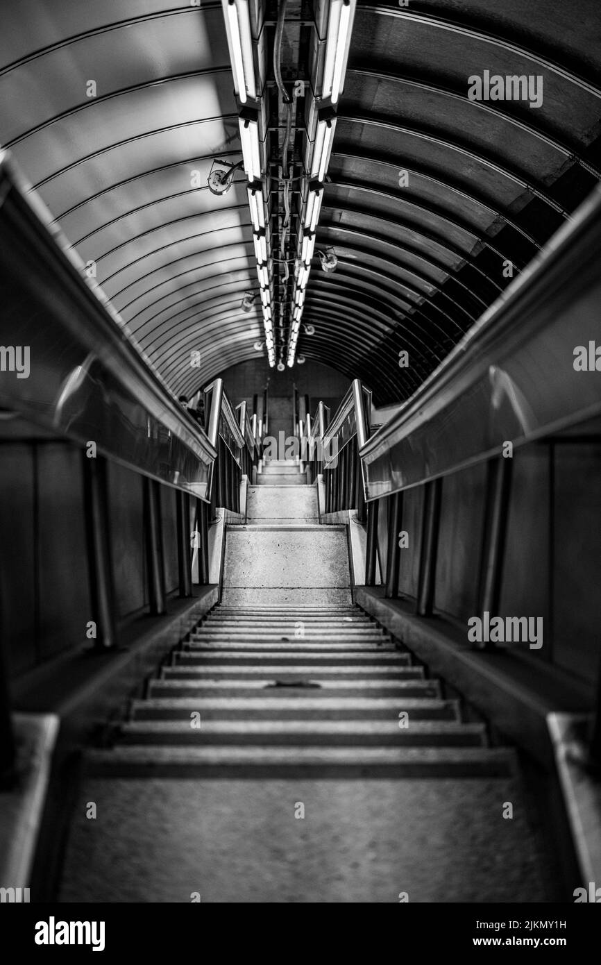 A vertical grayscale shot of a London underground stairs Stock Photo ...