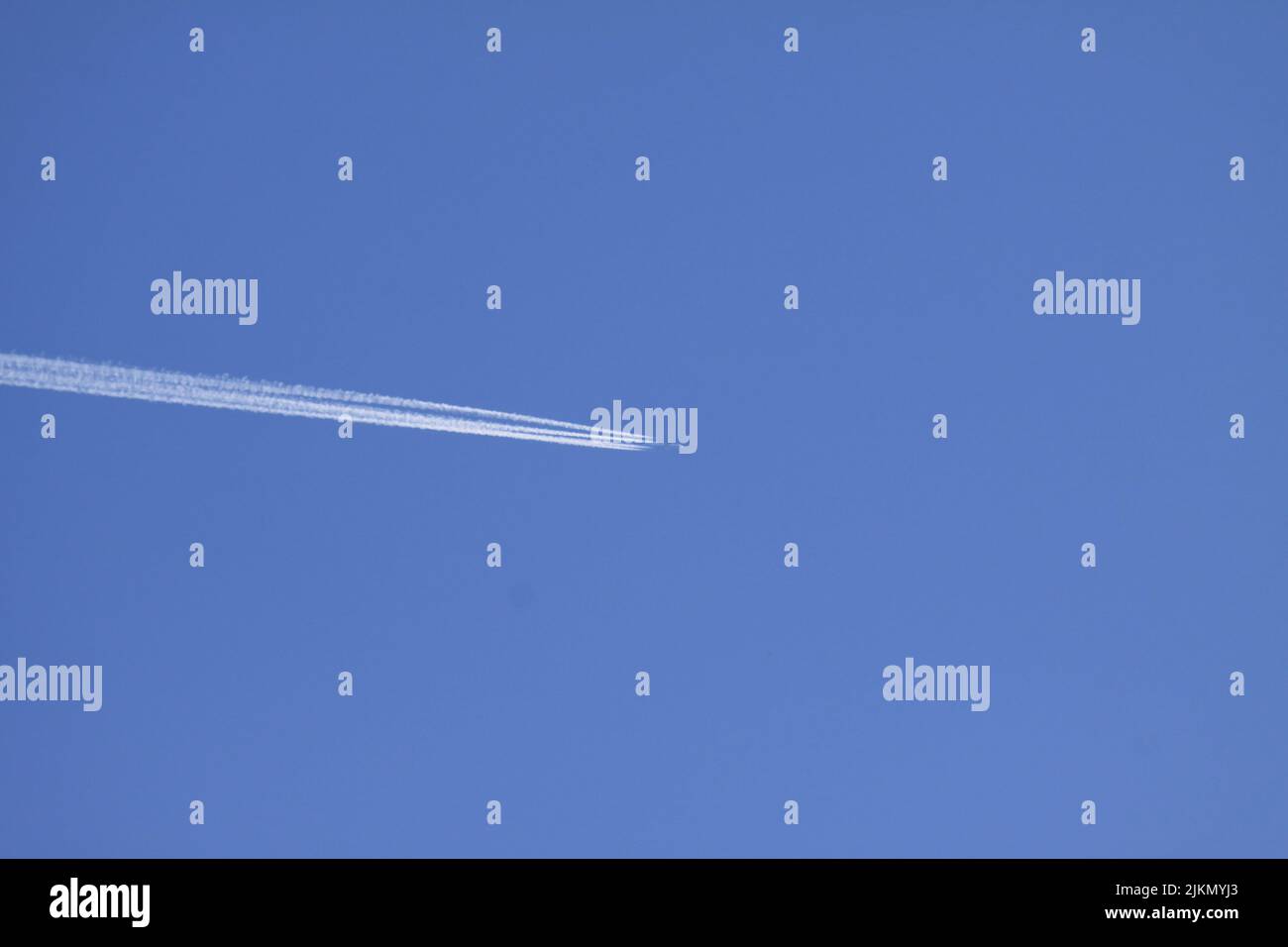 A low angle shot of vapor trails plane trail in the clear skies Stock ...