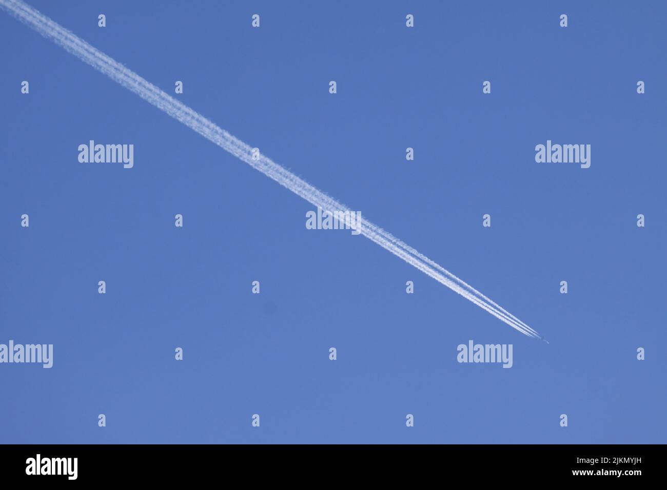 A low angle shot of vapor trails plane trail in the clear skies Stock ...