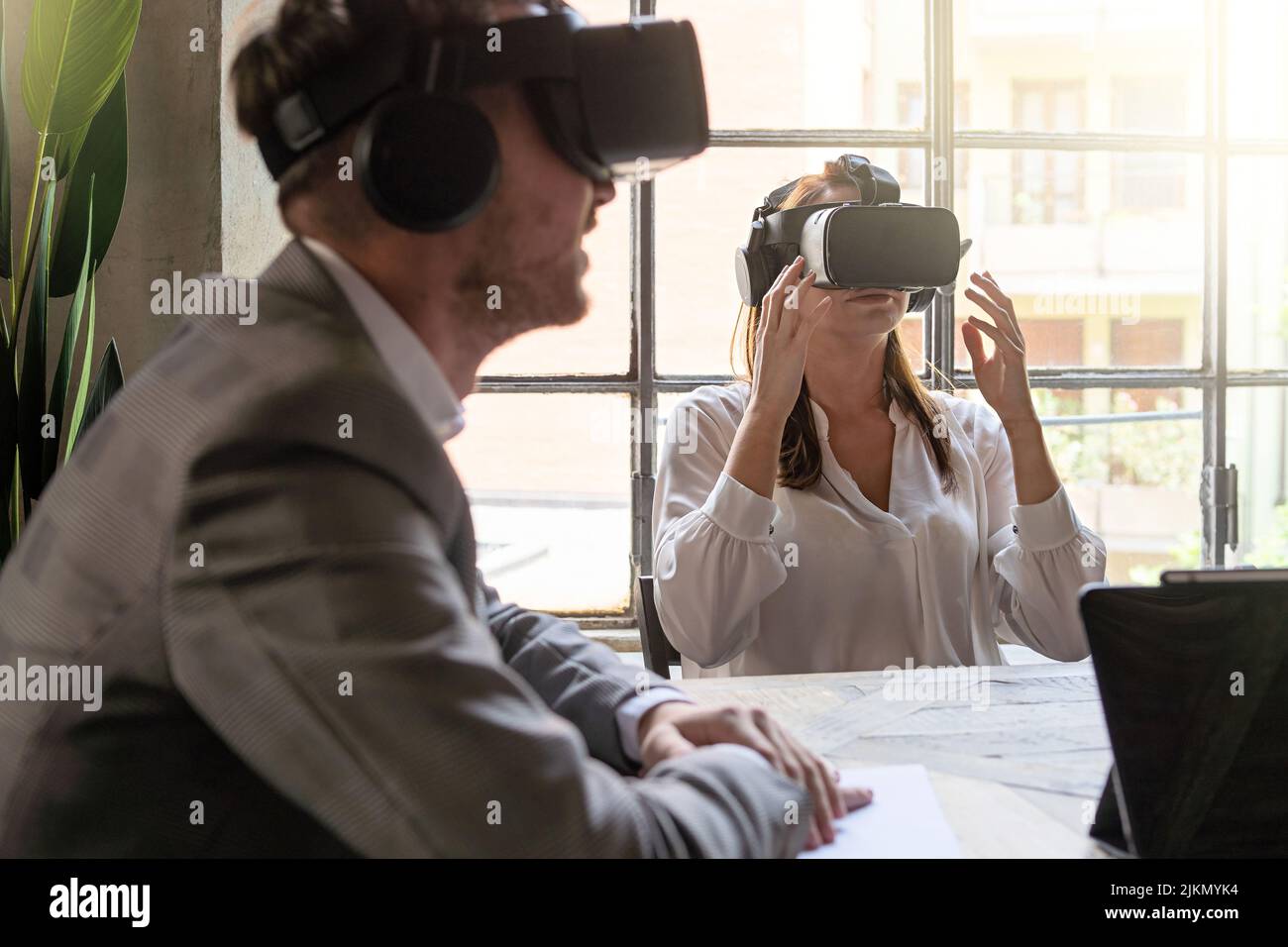 Young entrepreneurs having a metaverse remote meeting using 360 VR ...