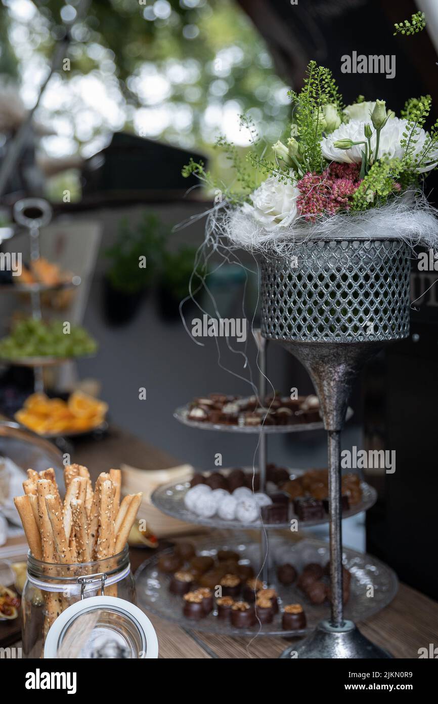 A vertical shot of different types of desserts and breadsticks on a ...