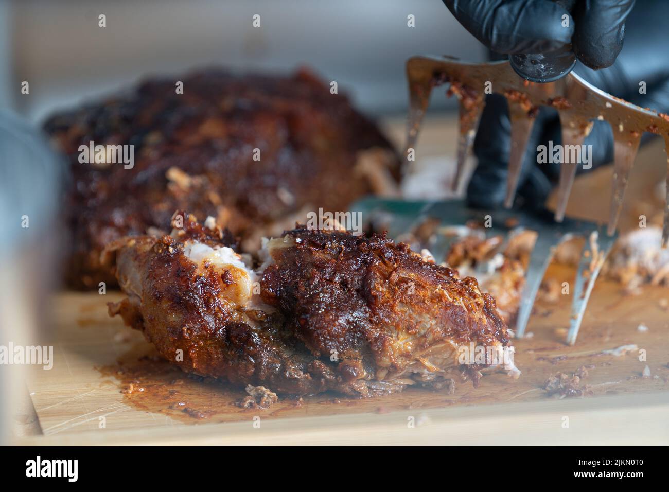 A chef slicing the well-cooked pork in the kitchen Stock Photo - Alamy