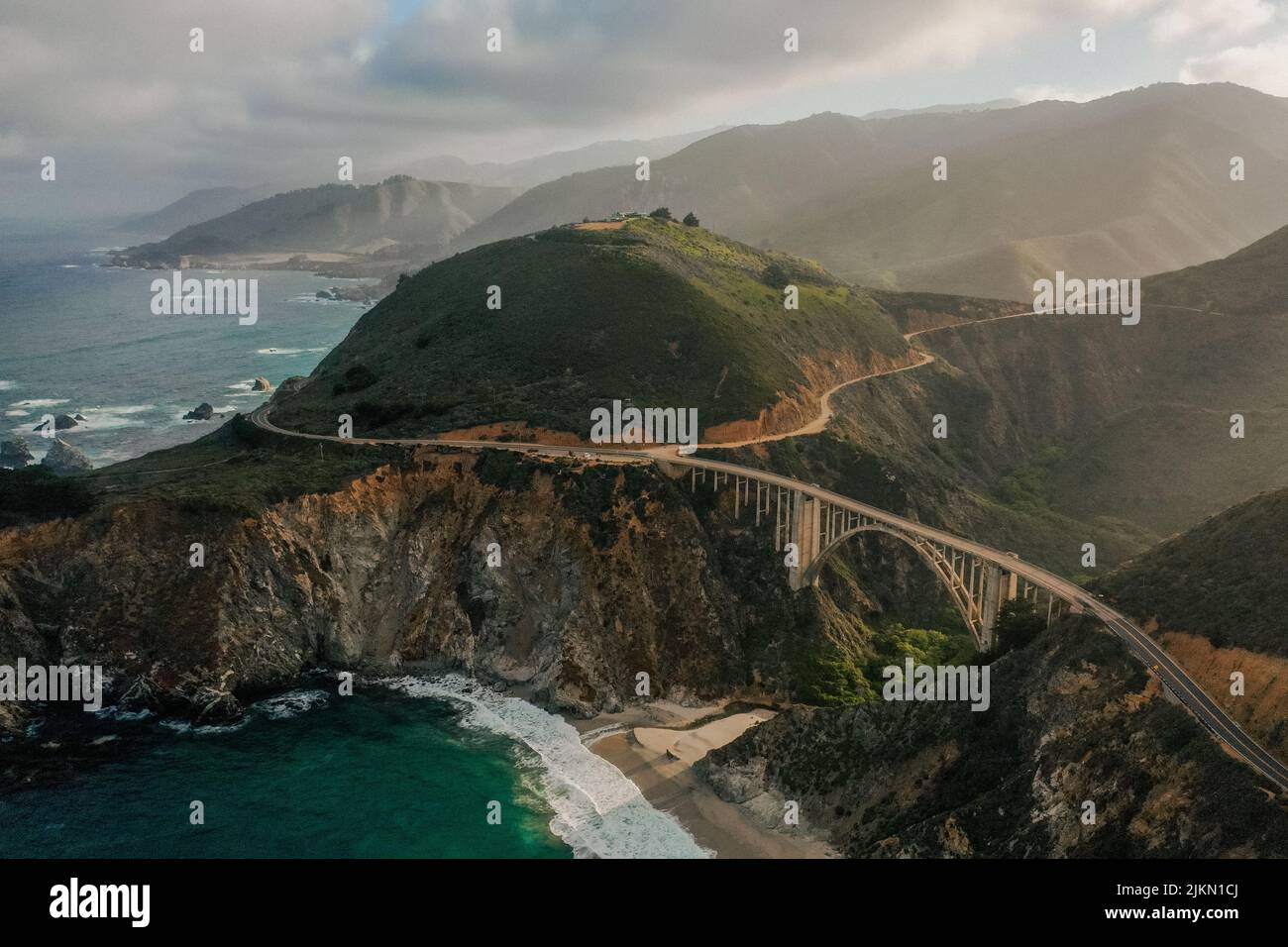a birds eye view shot of bridge going over mountains Stock Photo - Alamy