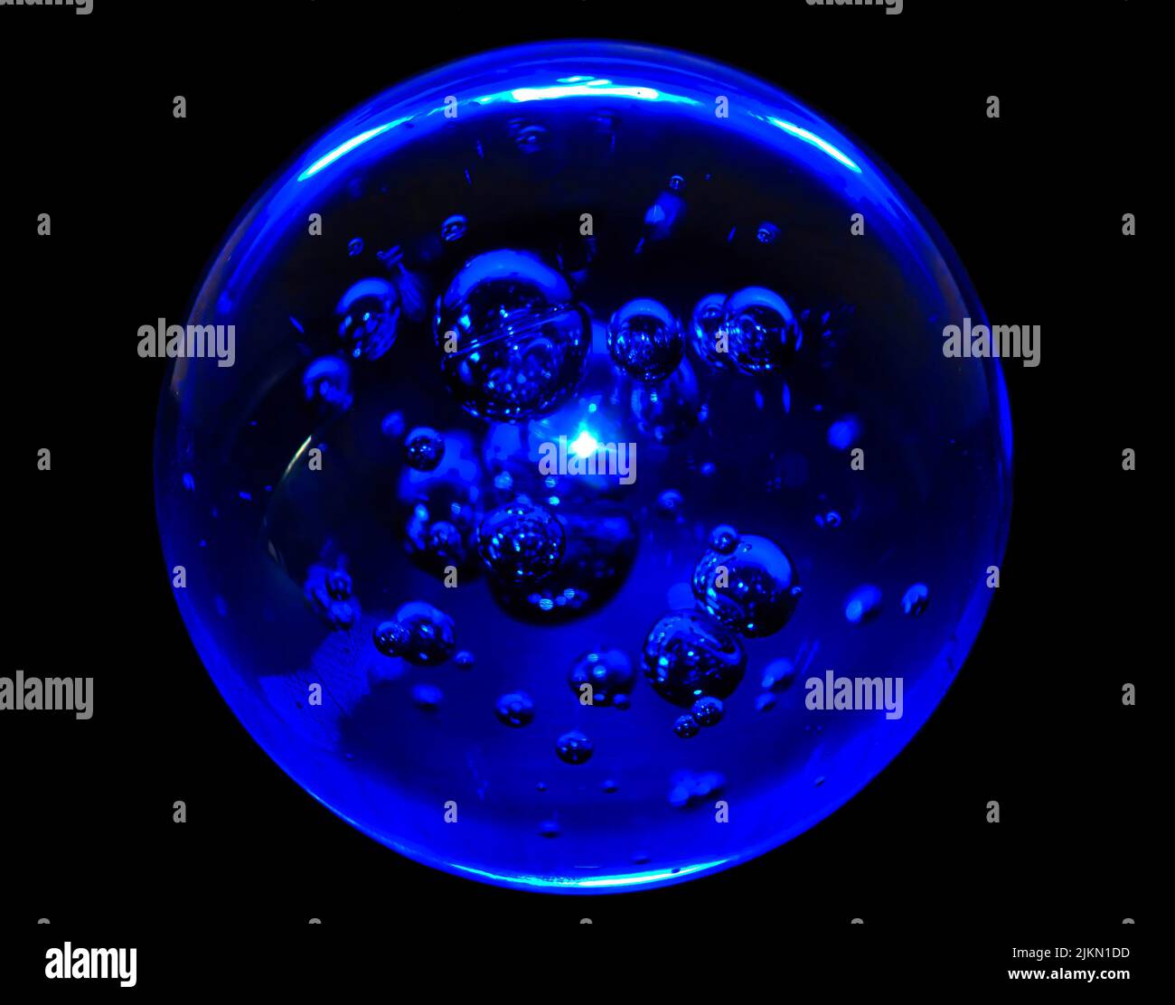 A closeup of a sphere with the bubbles in it and a blue illumination ...