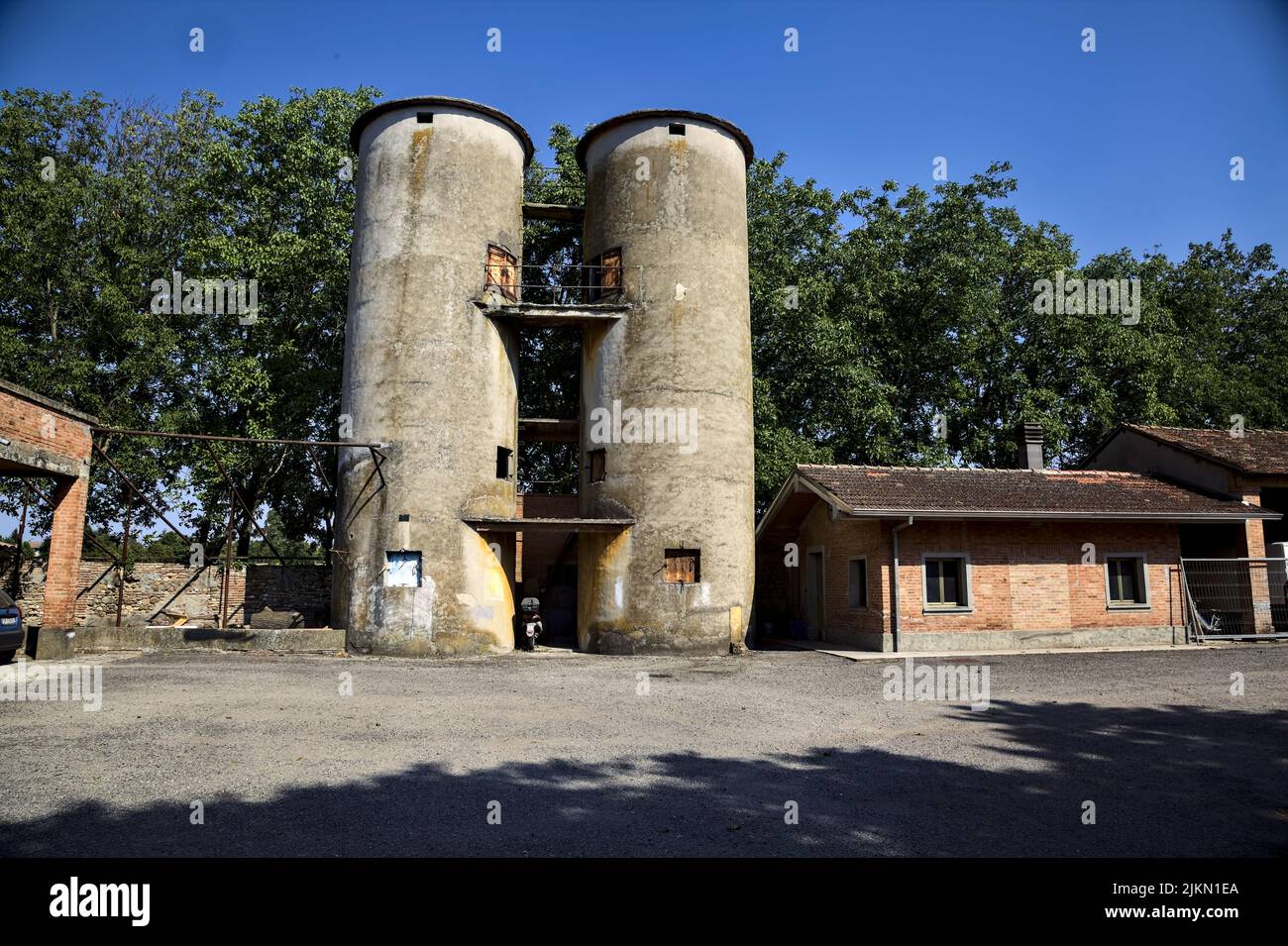 Old silos in a court next to worn buildings Stock Photo - Alamy