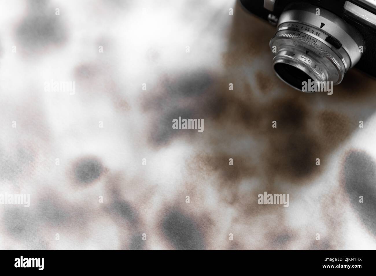 A closeup of a vintage camera on a white background with the burnt ...