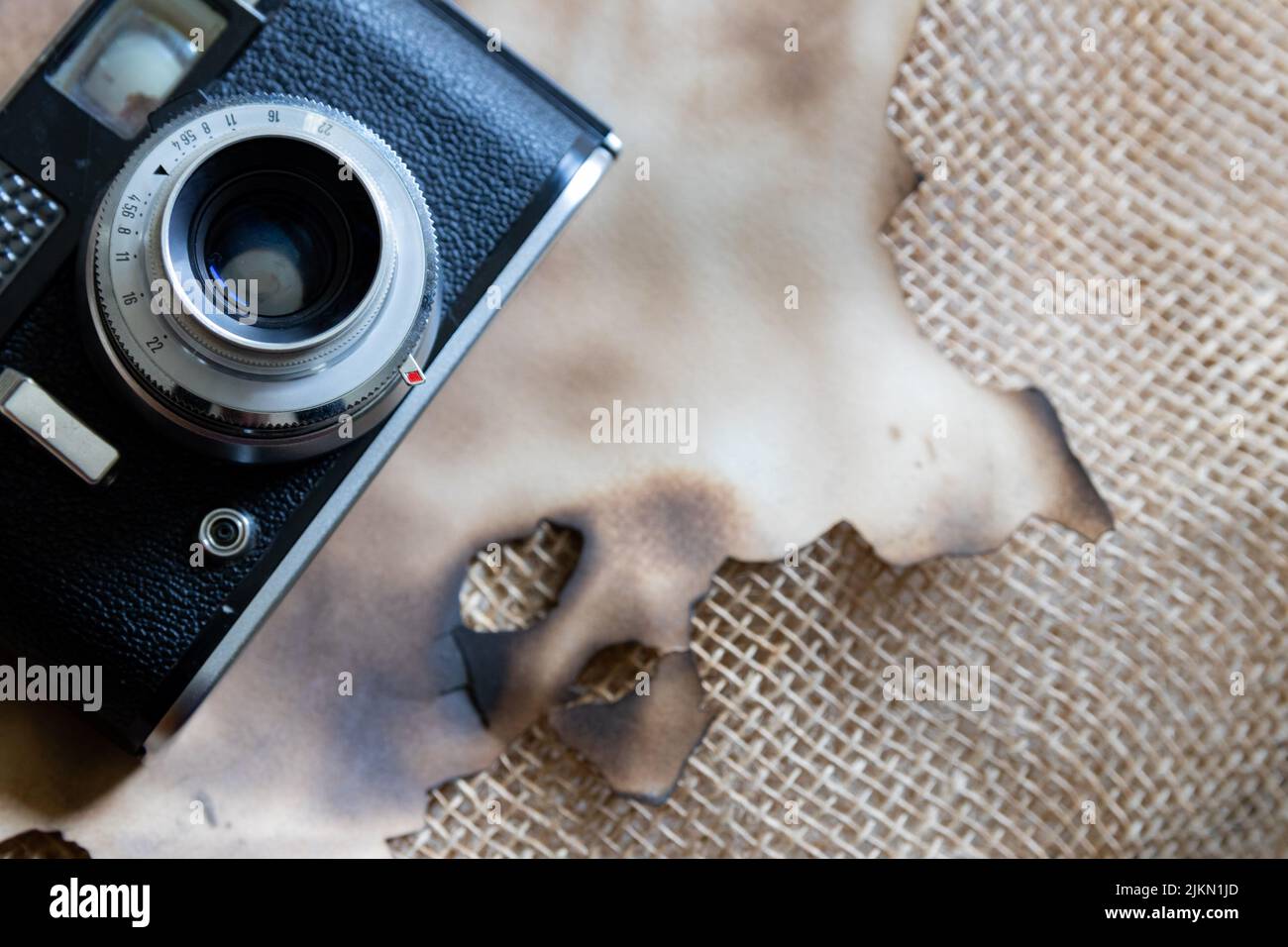 A closeup of a vintage camera on a white background with the burnt ...