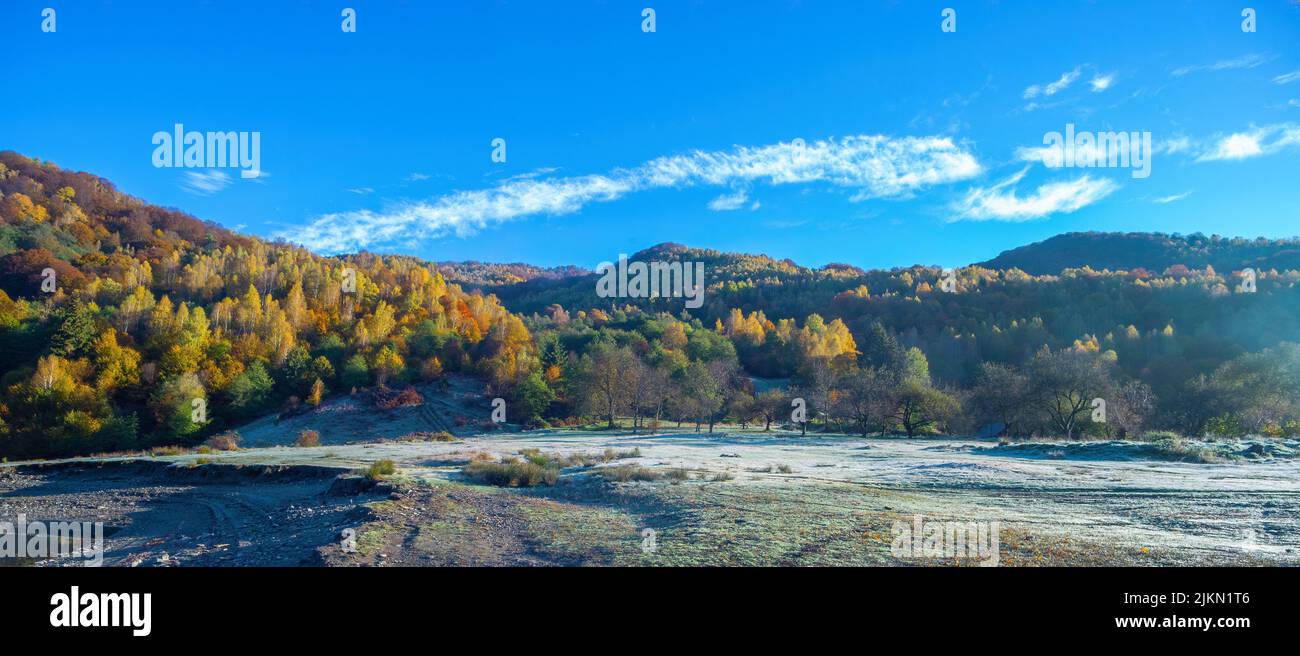 A panoramic view of a landscape of the hills covered by forest with ...