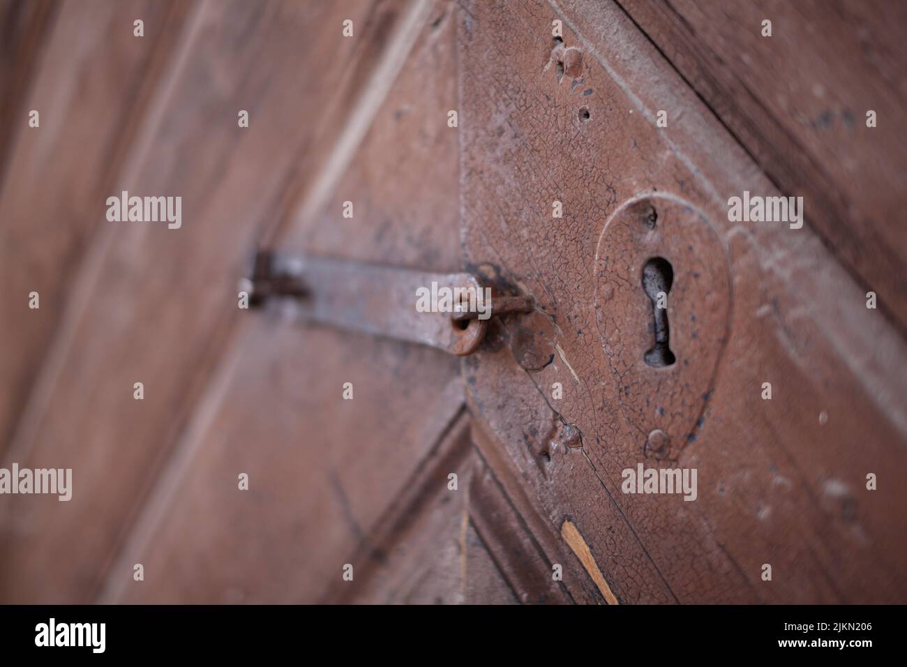 A close up shot of a lock on an old, rusty door Stock Photo - Alamy