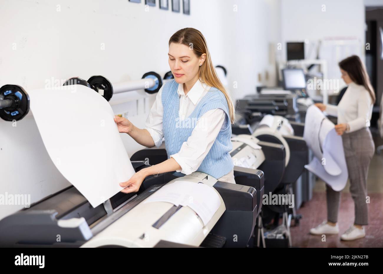 Print worker controlling printing process on modern offset machine in ...