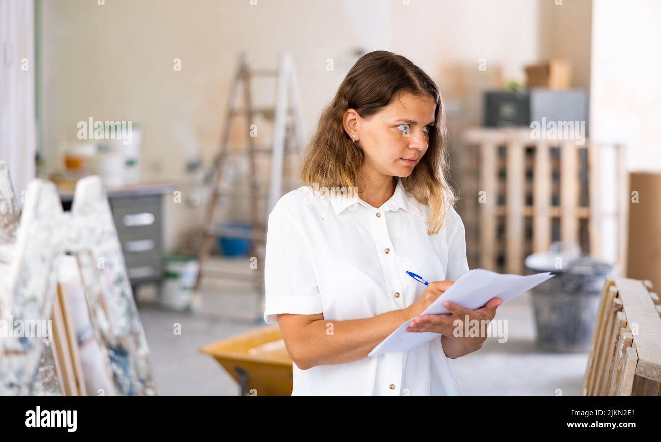 Woman construction manager checking project documentation Stock Photo ... Woman construction manager checking project documentation Stock Photo ...