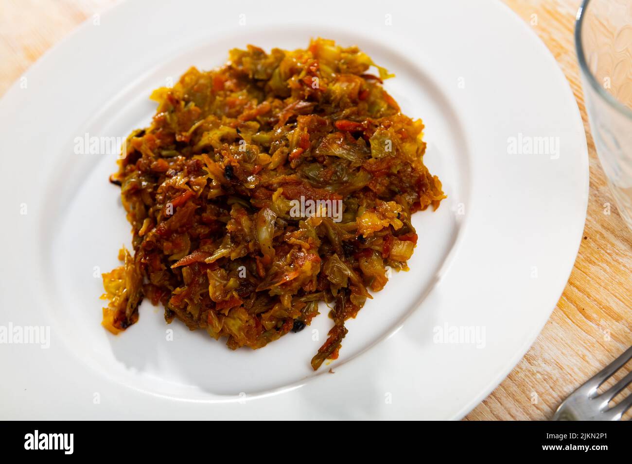 Stewed white cabbage with vegetables served on plate Stock Photo - Alamy