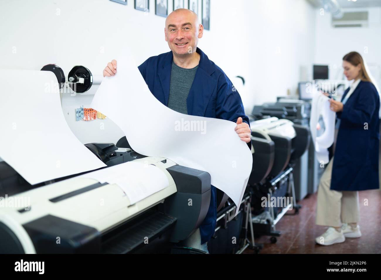 Service engineer of printing house during work Stock Photo - Alamy