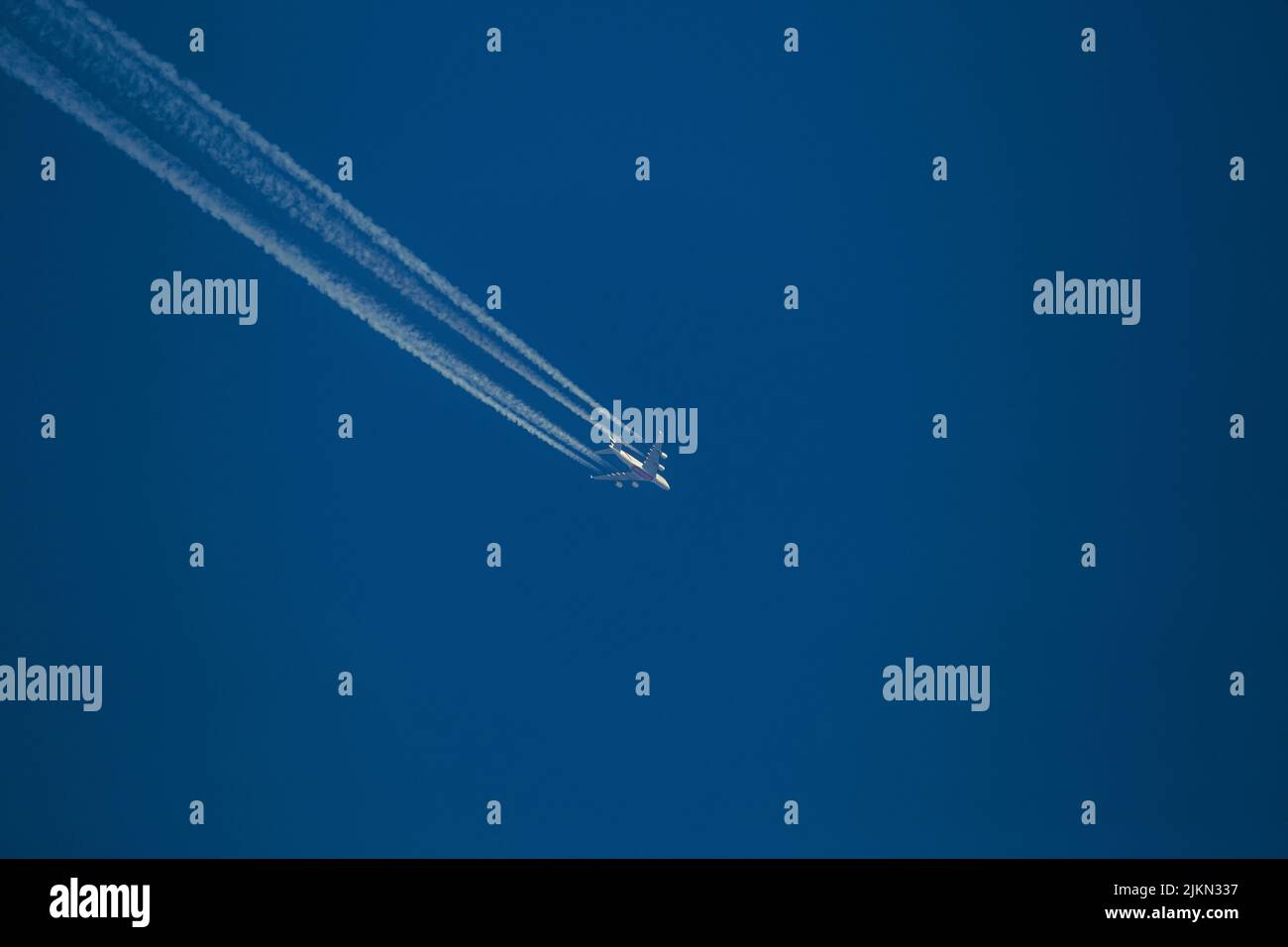 The airplane contrails in the clear blue sky Stock Photo - Alamy