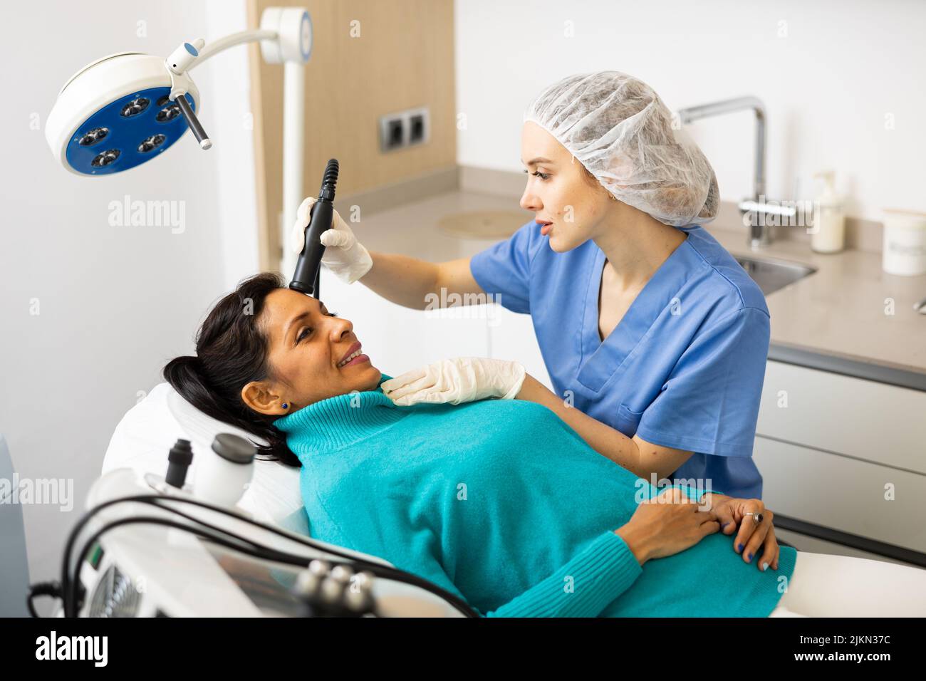 Woman receiving face ultrasound lifting procedure Stock Photo - Alamy