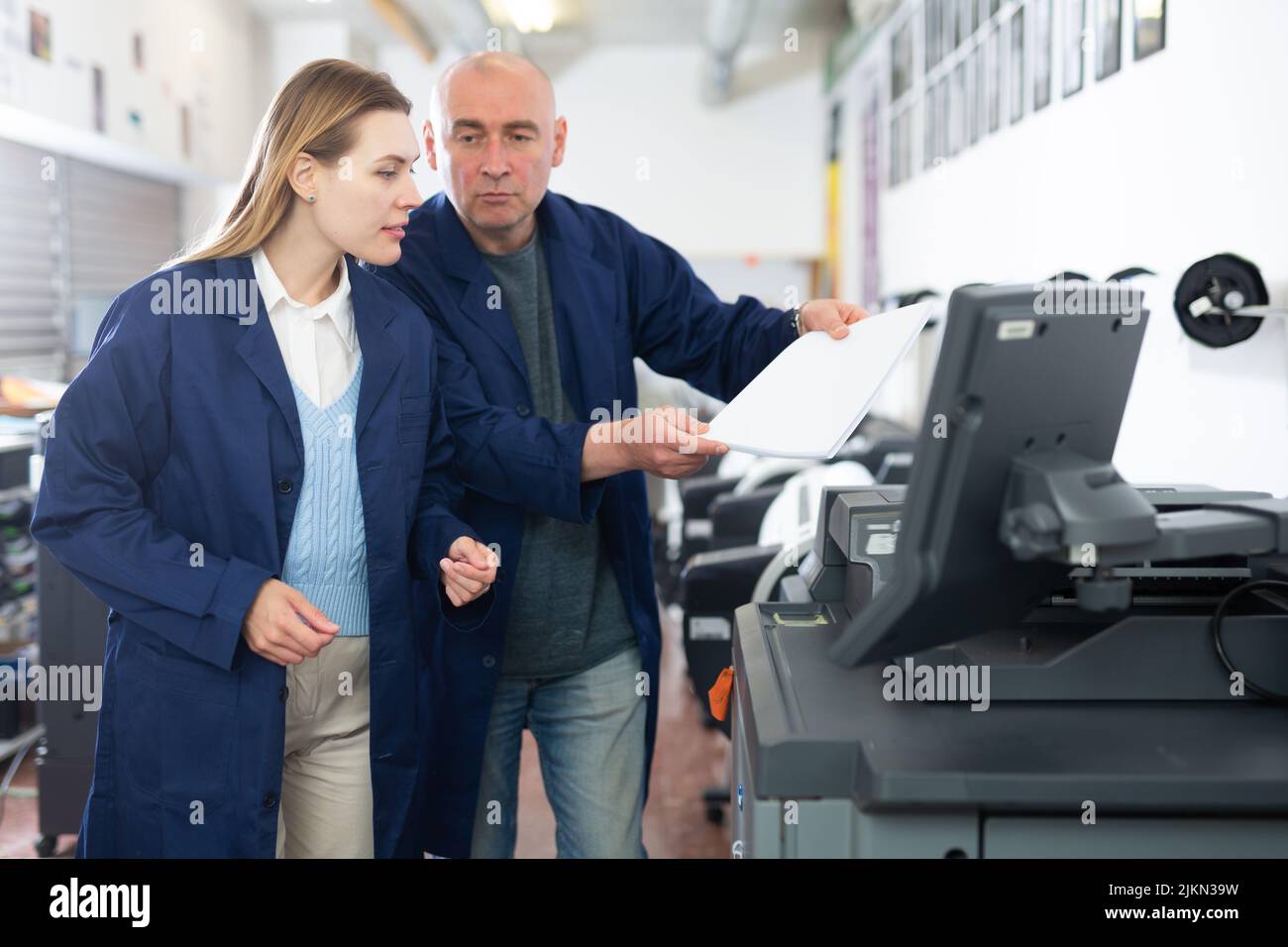 Service engineer conducts training on work on copiers of an office ...