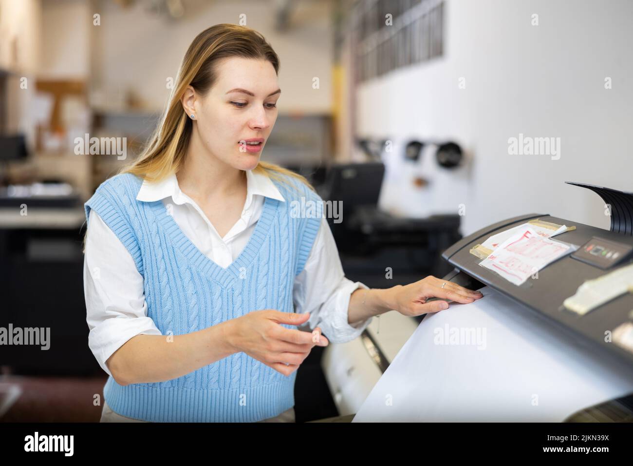 Woman working in publishing facility Stock Photo - Alamy