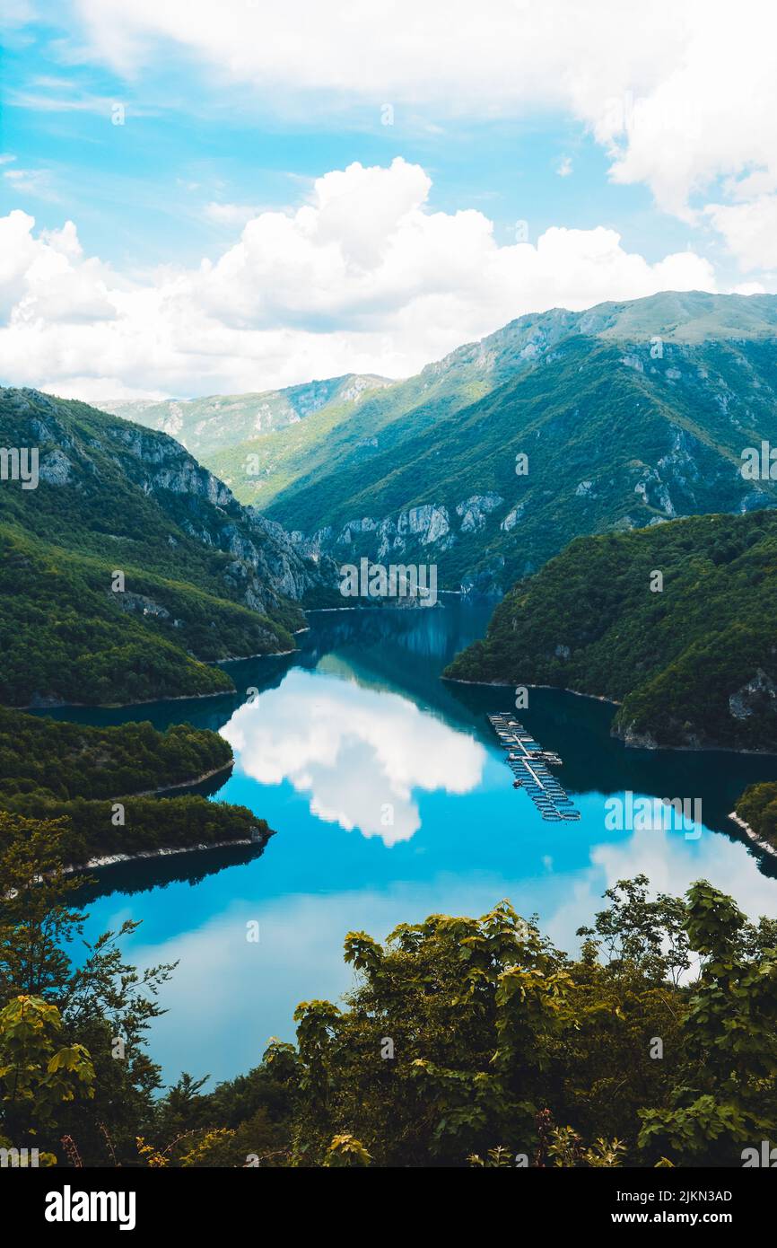 A vertical shot of the beautiful landscape with green mountains and the ...