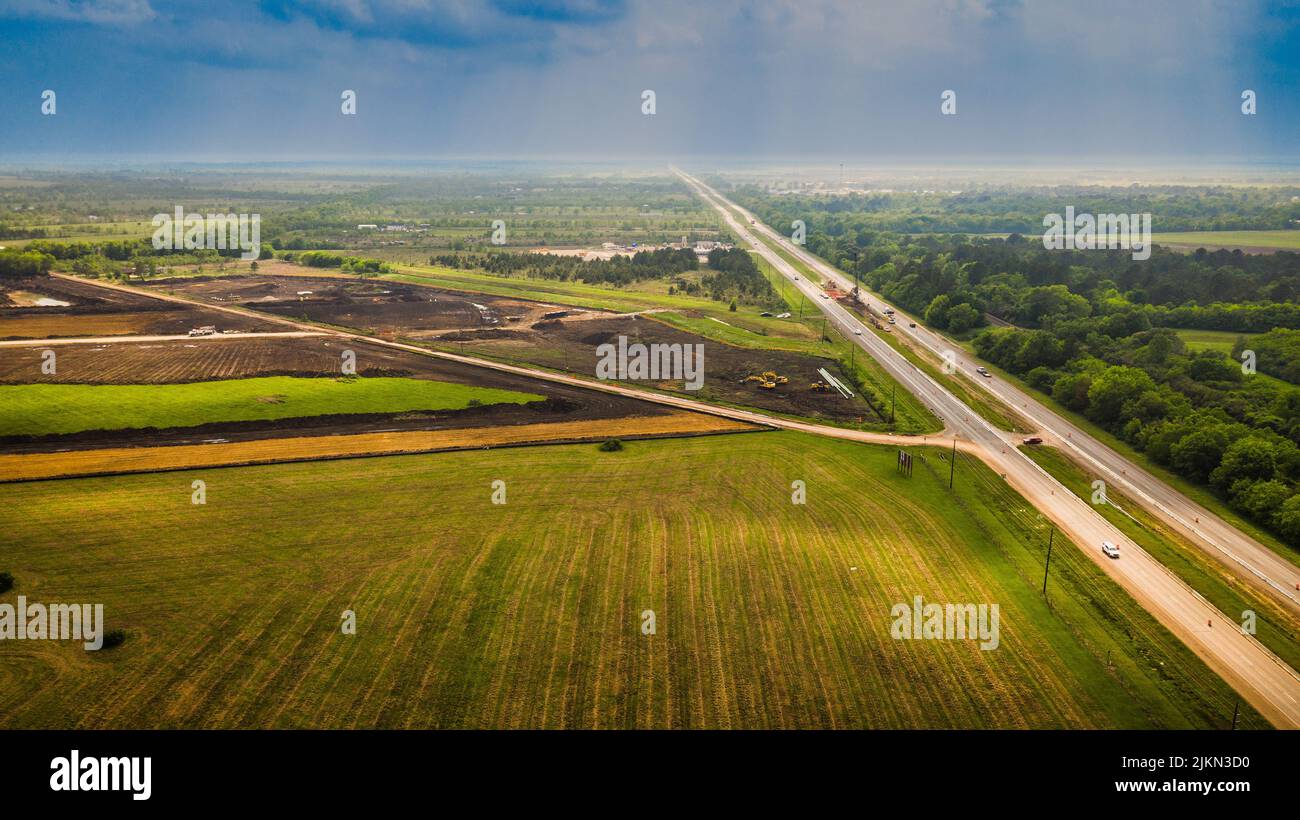 An aerial drone shot of a rural area in the country with cars passing the highway Stock Photo ...