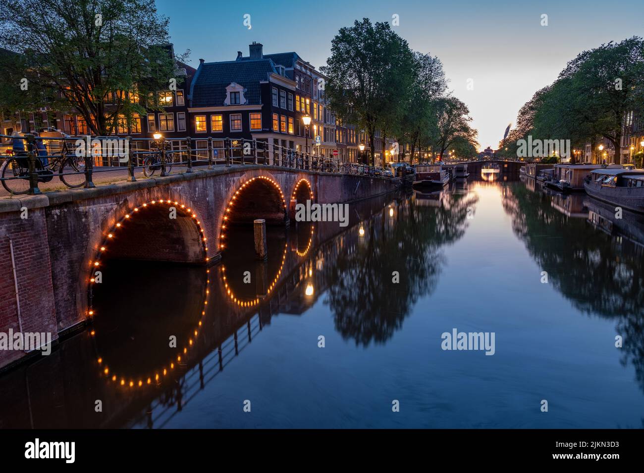 A beautiful night city view of Amsterdam canal and bridge, Netherlands ...