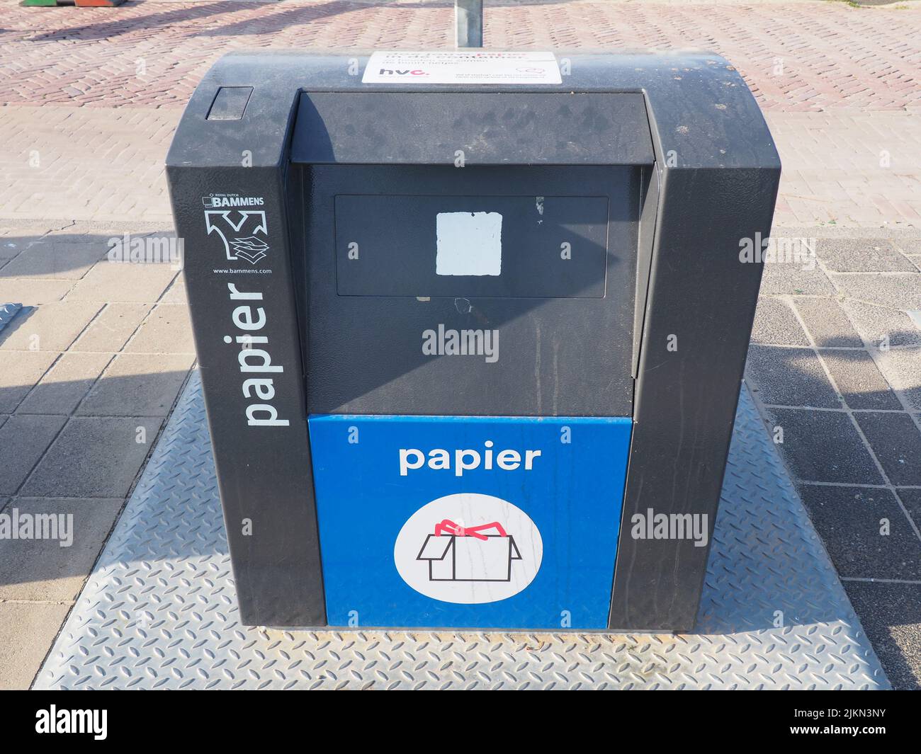 A modern semi-ground paper recycling container with a cardboard symbol ...