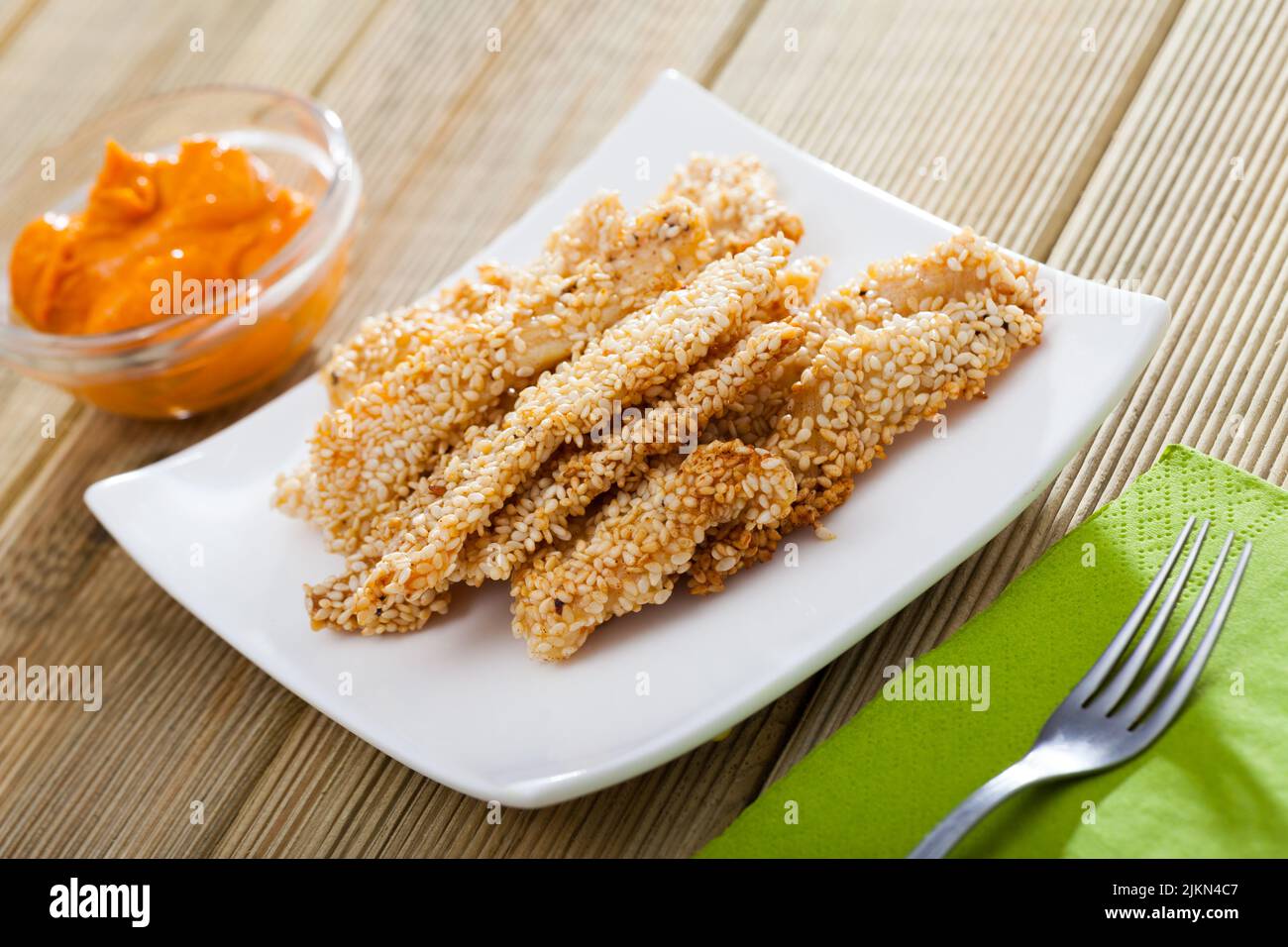 Chicken fingers in sesame with sauce Stock Photo - Alamy