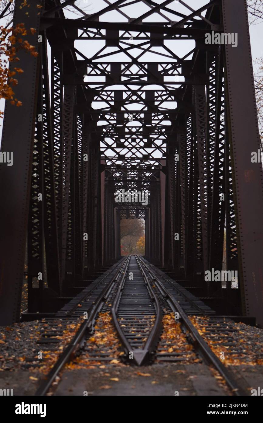 The train trestle with fallen autumn leaves on the train tracks Stock ...