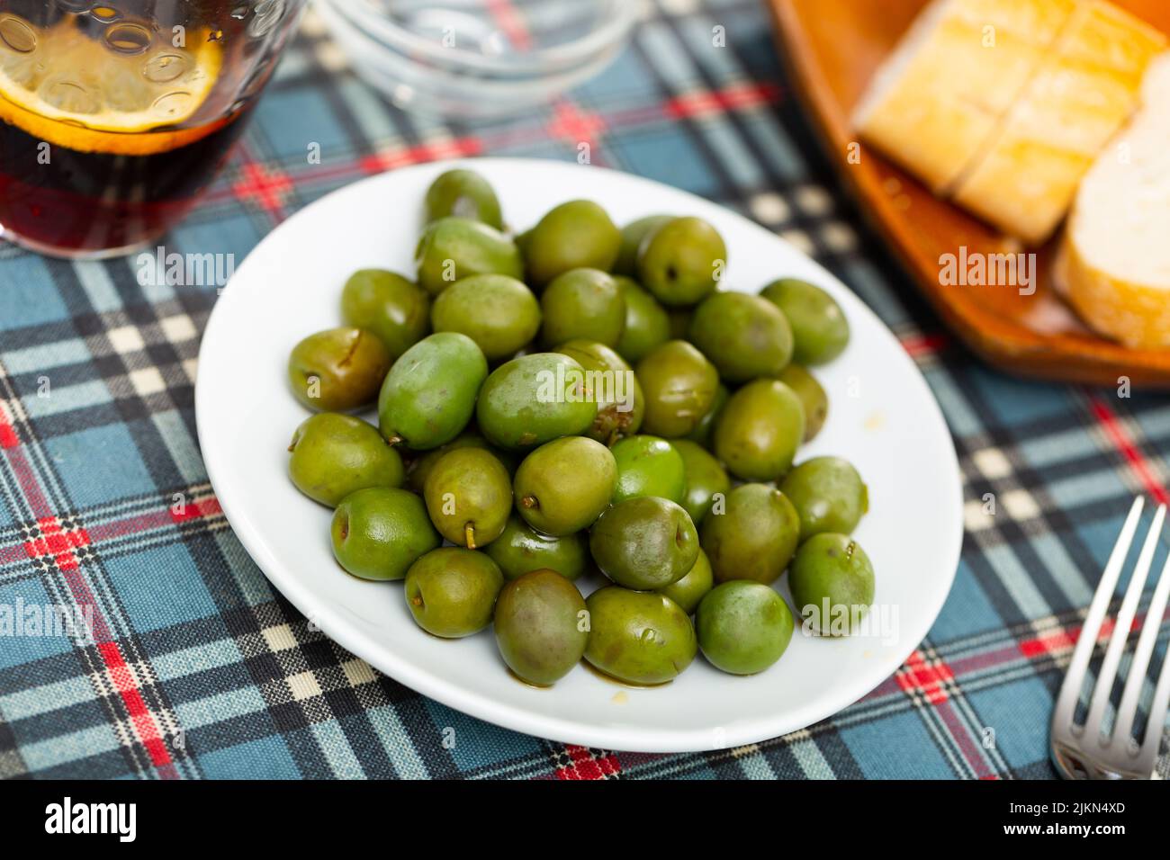 Pickled green olives with a stone Stock Photo - Alamy