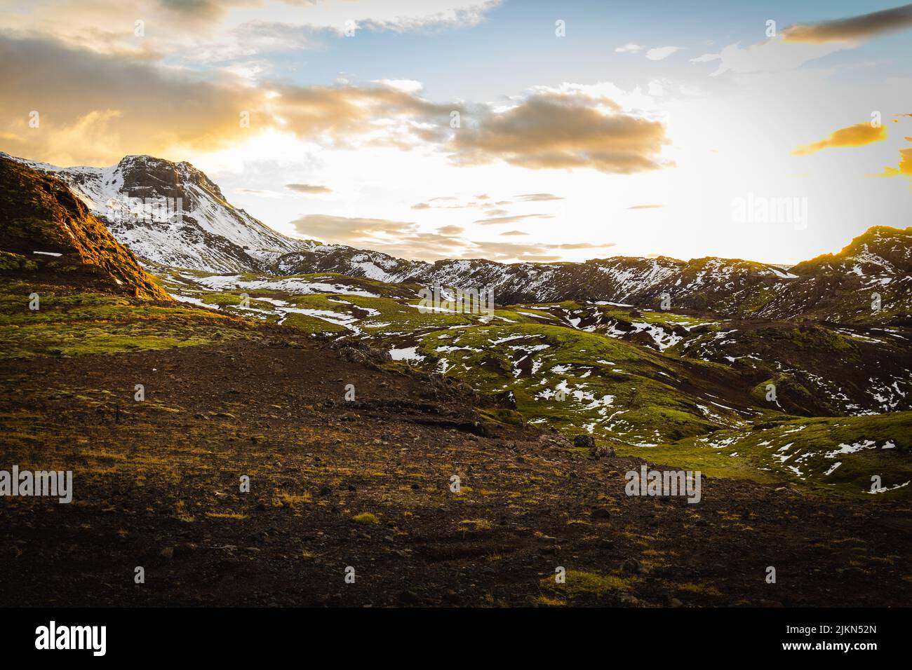A beautiful landscape view of snowy mountains on grassland with a ...