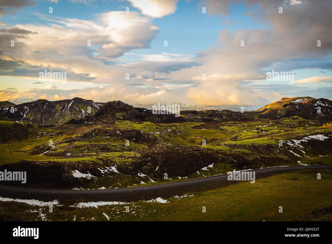 A beautiful landscape view of snowy mountains on grassland with a ...