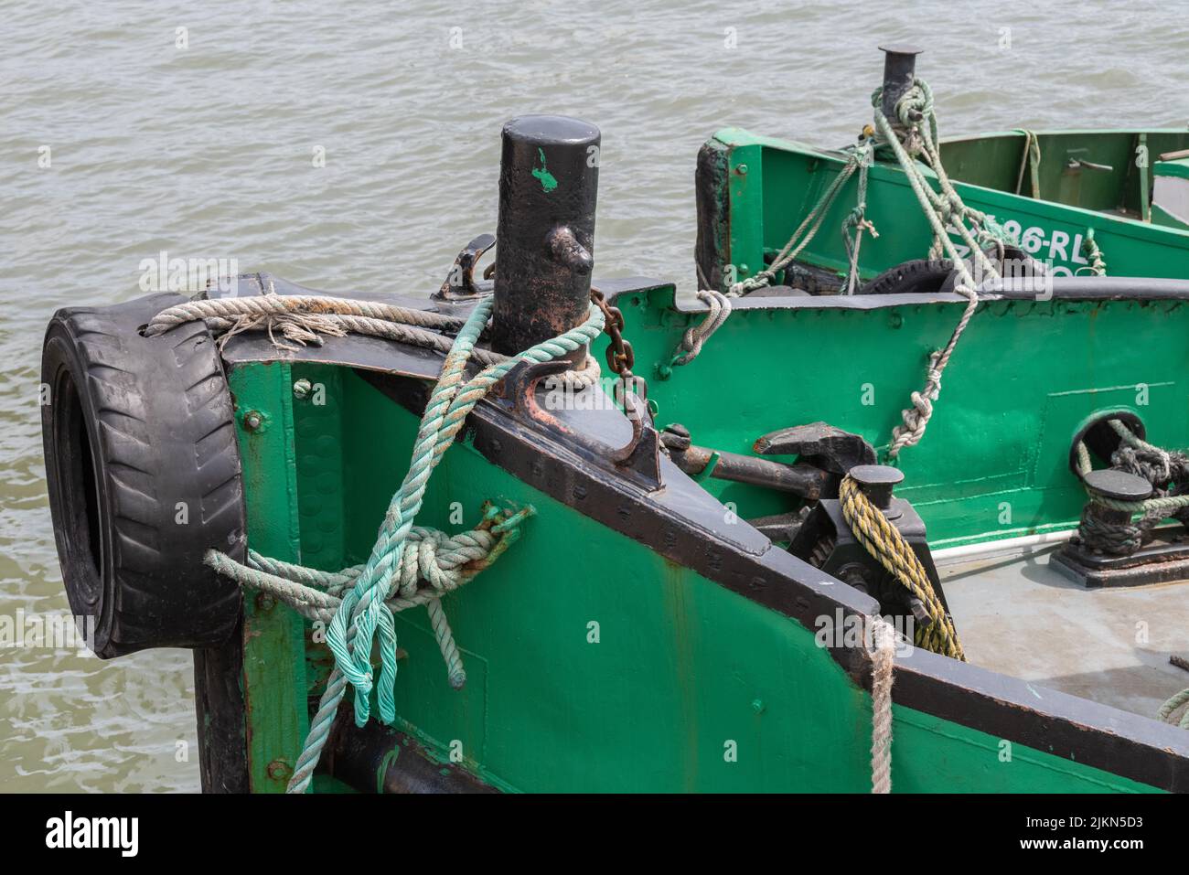 A closeup shot of the bow - the front of the boat with a wheel and ...