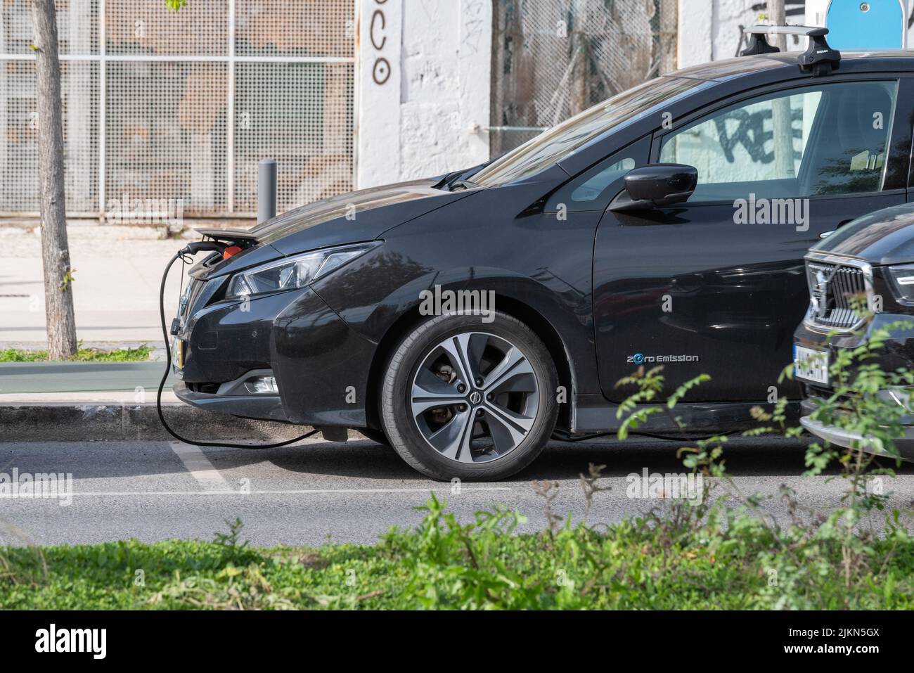A closeup shot of a side view of an electric vehicle parked on the ...
