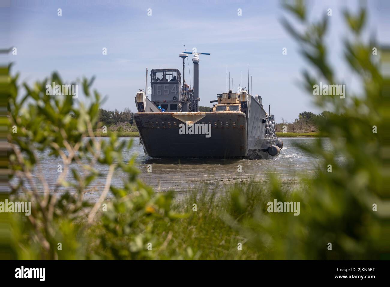 A joint light tactical vehicle is transported aboard U.S. Navy landing ...