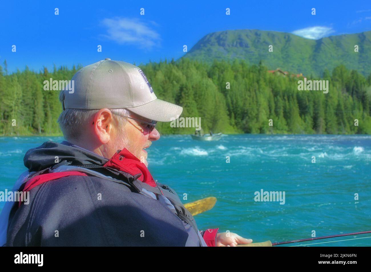 An older man intently watches his line, while fly fishing on the Kenai ...