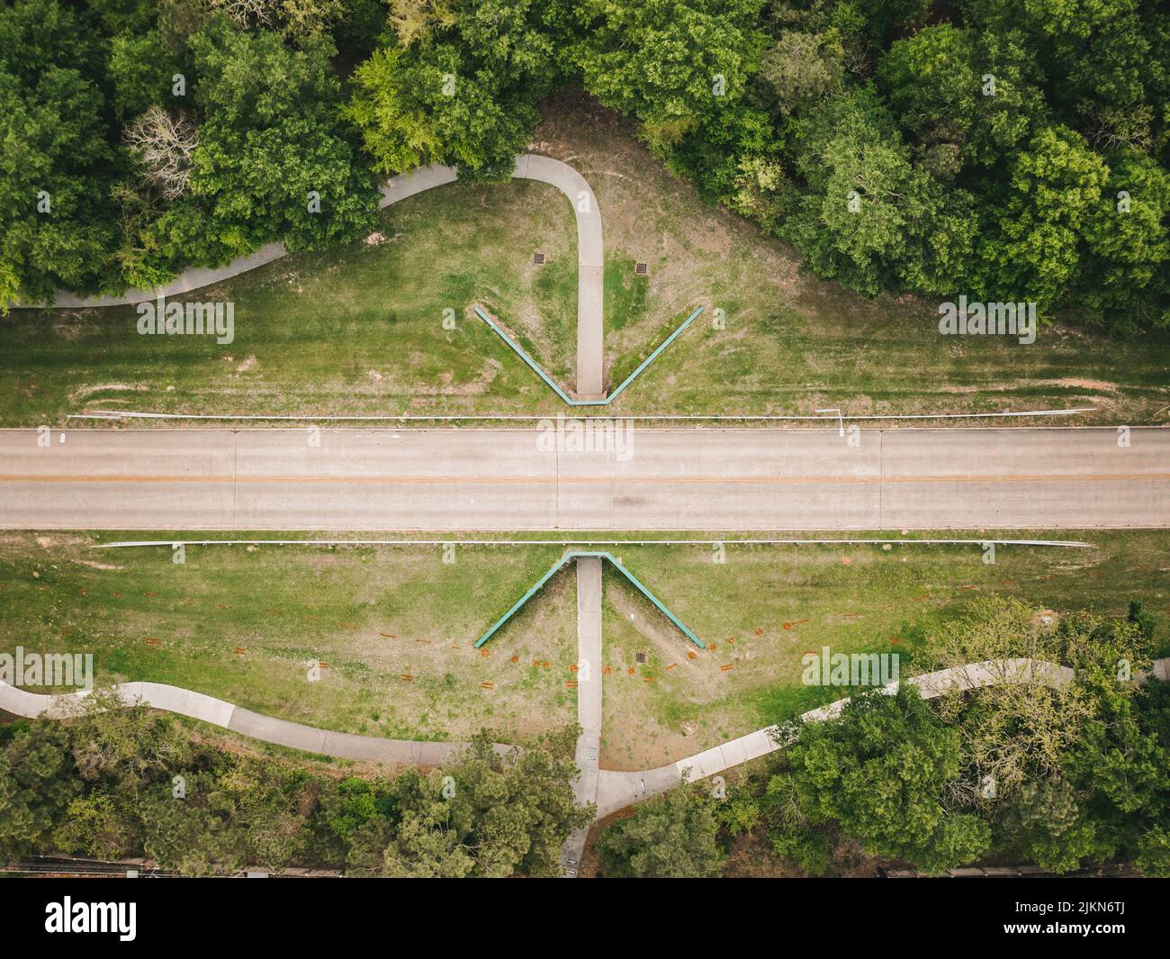 An aerial view of a road with arrows through the forest under the ...