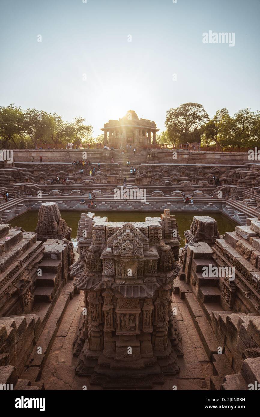 A vertical shot of the Sun Temple at the Modhera village at sunset ...