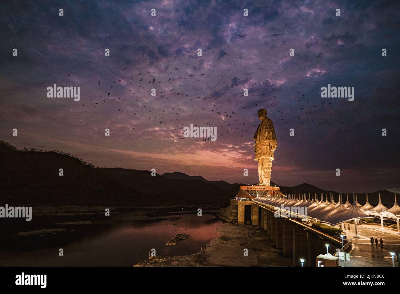 A beautiful shot of a statue of Unity in India against a cloudy sky at ...