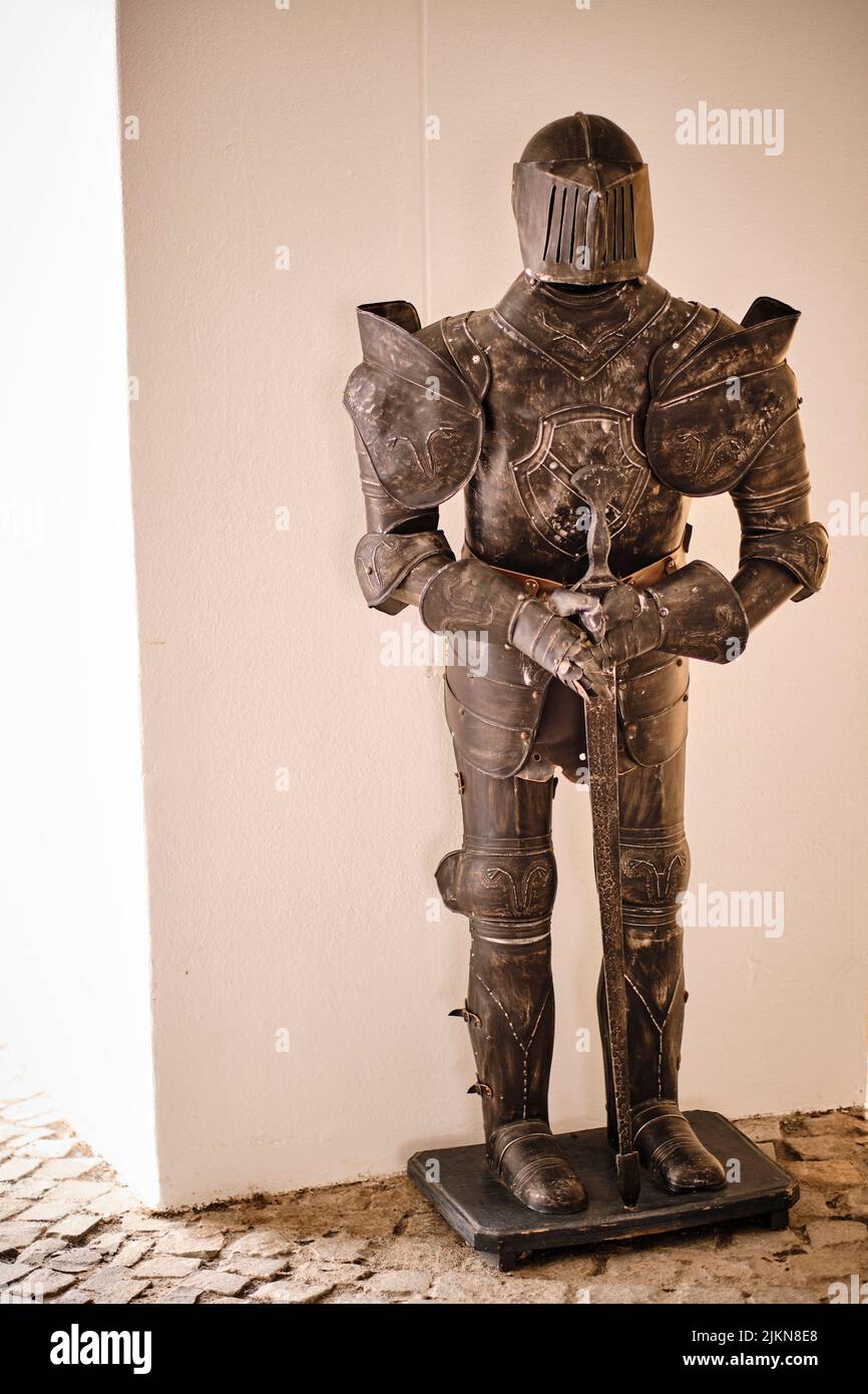 A vertical shot of an iron Knight armor sculpture in a building in ...