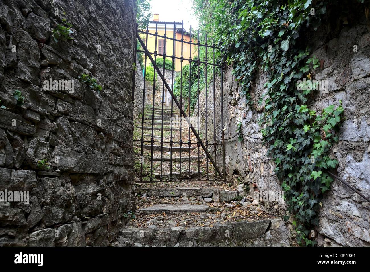 Closed gate at the end of a stone staircase bordered by stone walls ...