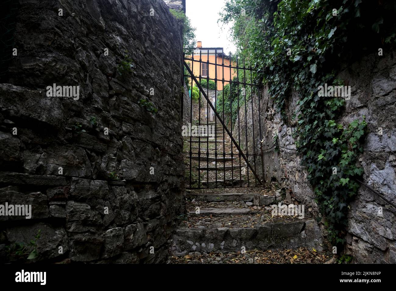 Closed gate at the end of a stone staircase bordered by stone walls ...