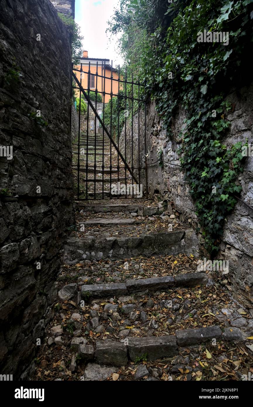 Closed gate at the end of a stone staircase bordered by stone walls ...