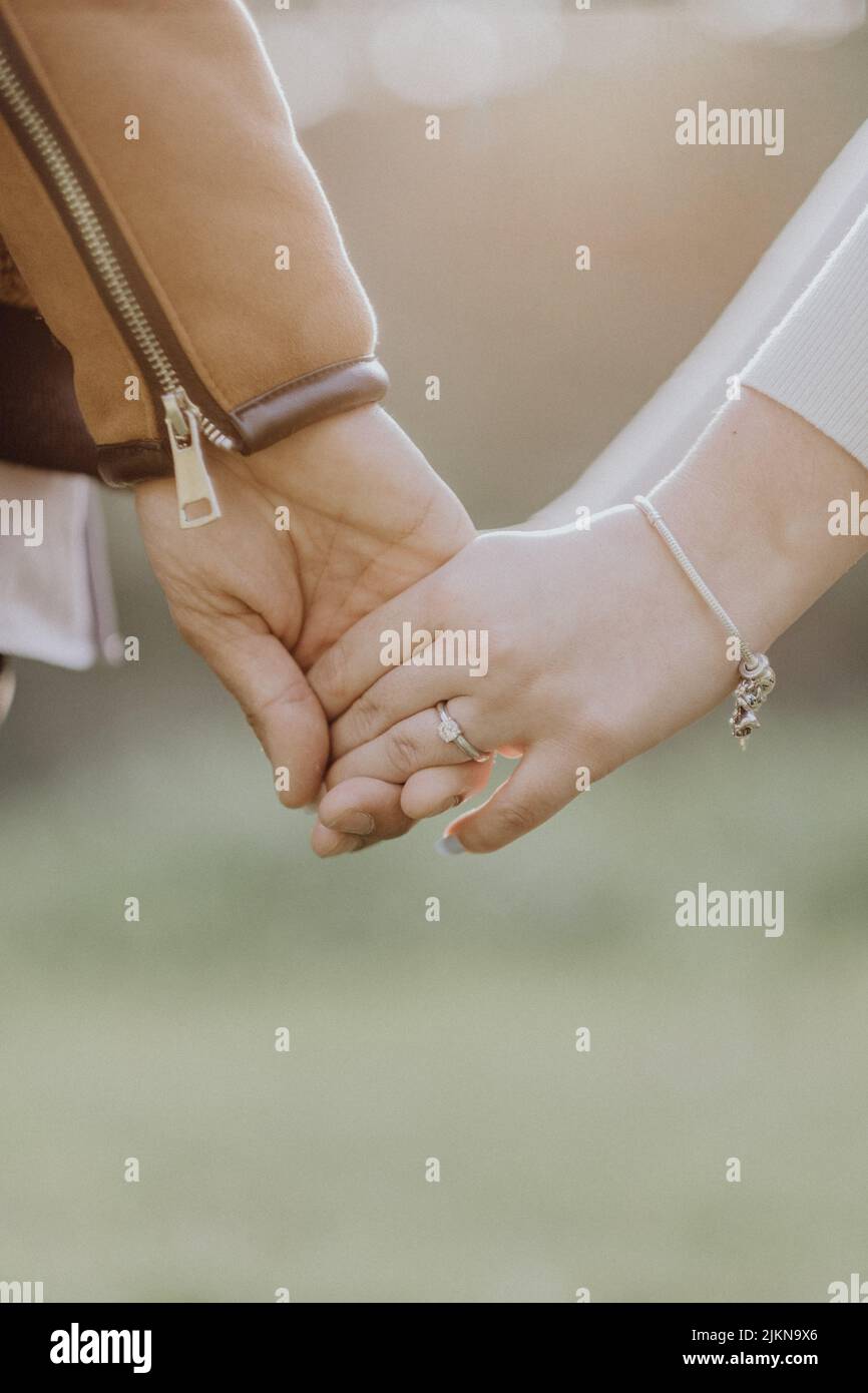 A married couple walking hand in hand on a blurred background Stock ...