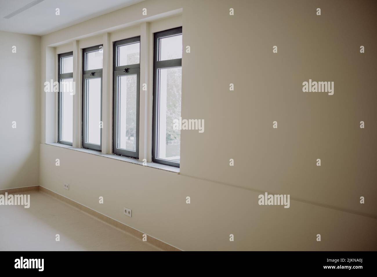 An interior of a white building with four glass windows Stock Photo - Alamy